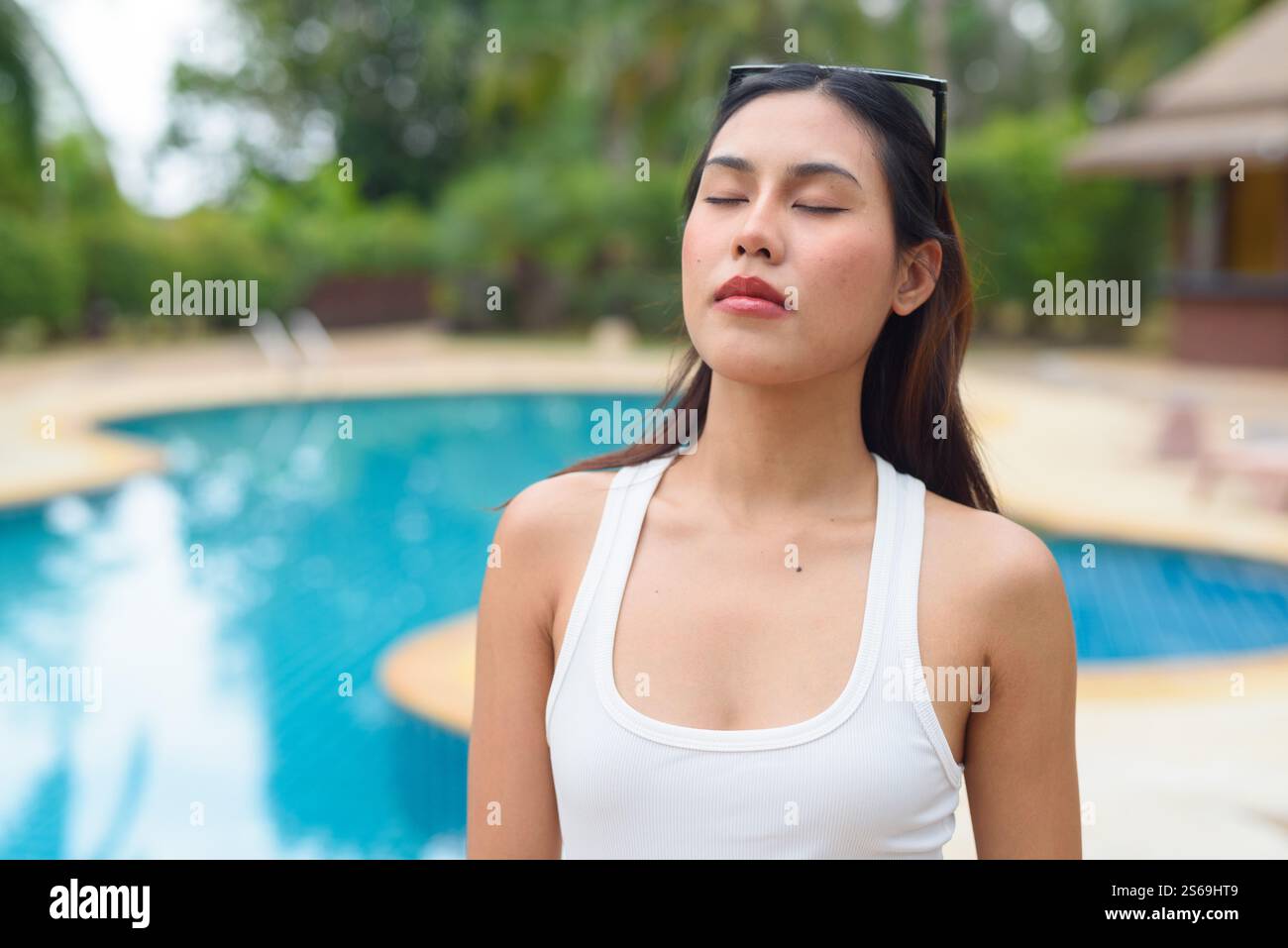Young Asian woman swimming pool portrait Stock Photo - Alamy