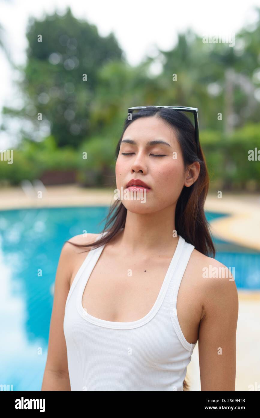 Young Asian woman swimming pool portrait Stock Photo - Alamy