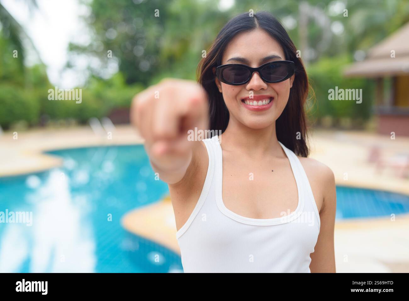Woman pointing finger resort pool hi-res stock photography and images ...