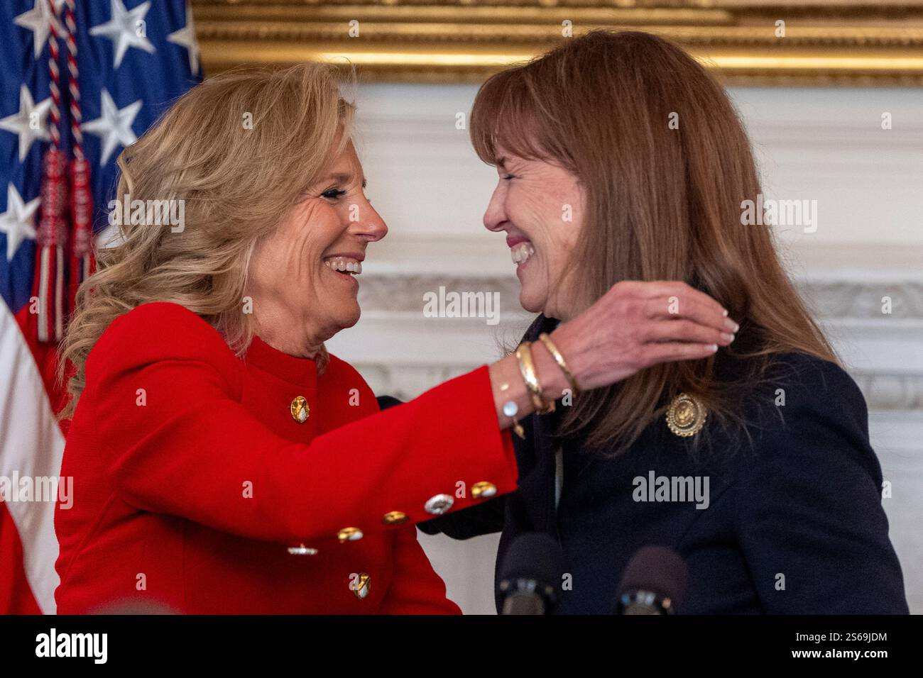 Sheila Casey, right, executive director of Joining Forces, embraces ...