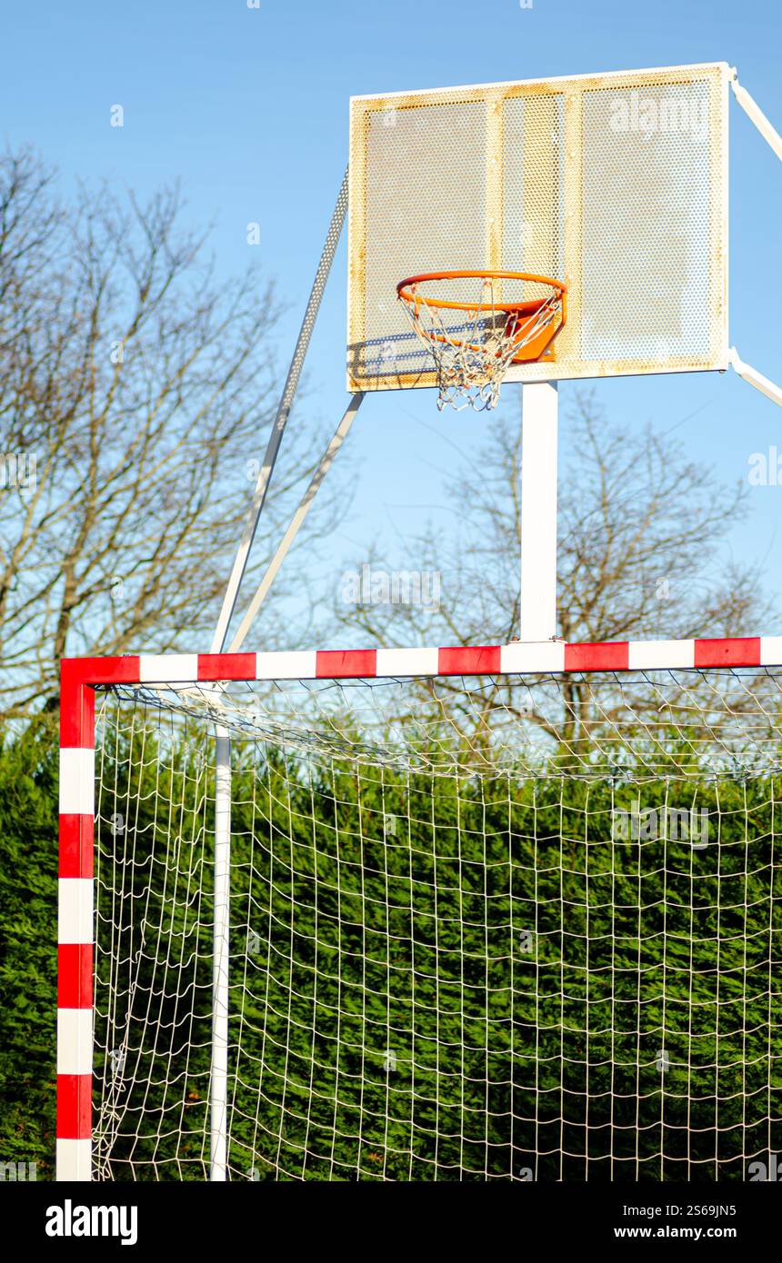 a basketball basket made of a rusty white metal backboard installed on ...