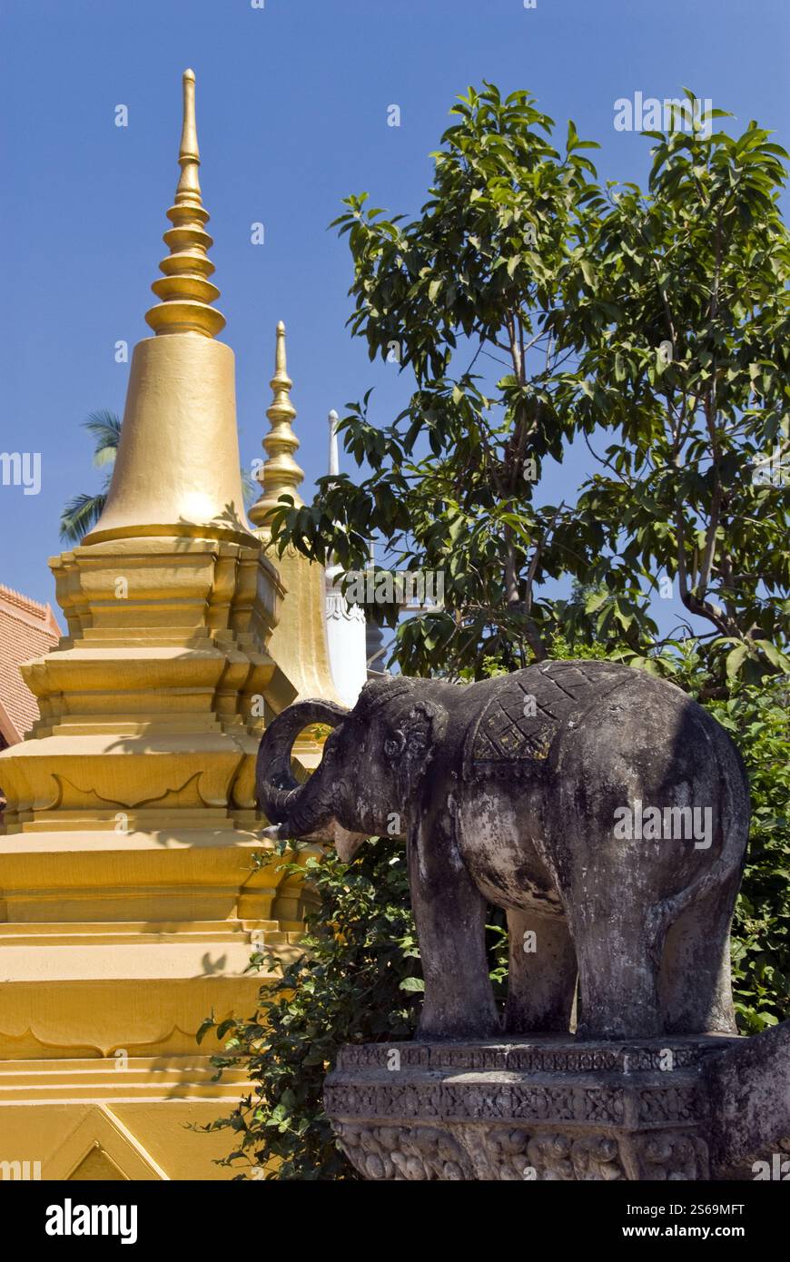 Grave stupas and stone elephant on the grounds of Wat Bo, one of the ...