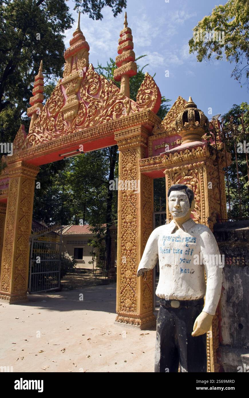 A concrete statue of a man tells visitors to "take off your hat," at ...