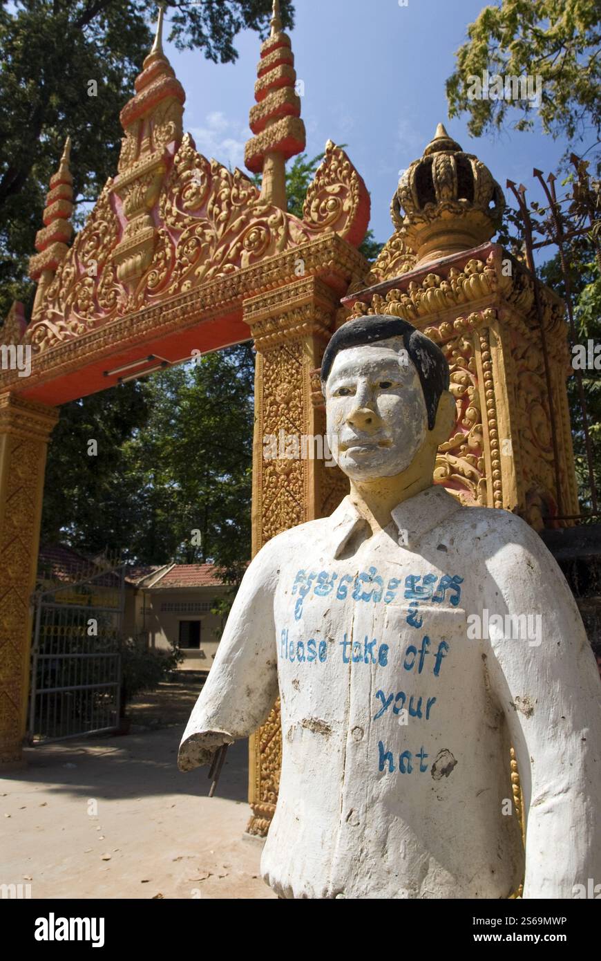 A concrete statue of a man tells visitors to "take off your hat," at ...