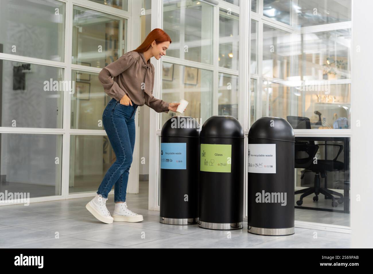 Woman choosing a proper container for throwing paper cup Stock Photo ...