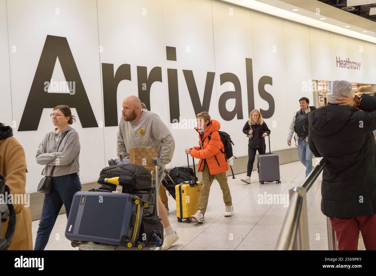 Air travellers arriving at Heathrow Arrivals Hall England UK Stock ...