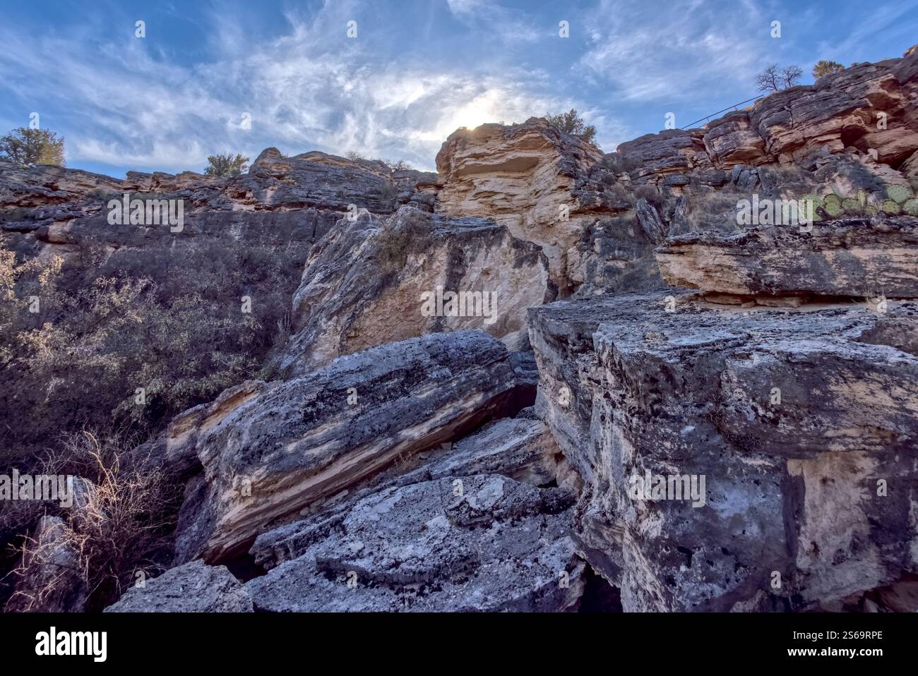 The sheer cliff walls of the ancient sinkhole known as Montezuma Well ...