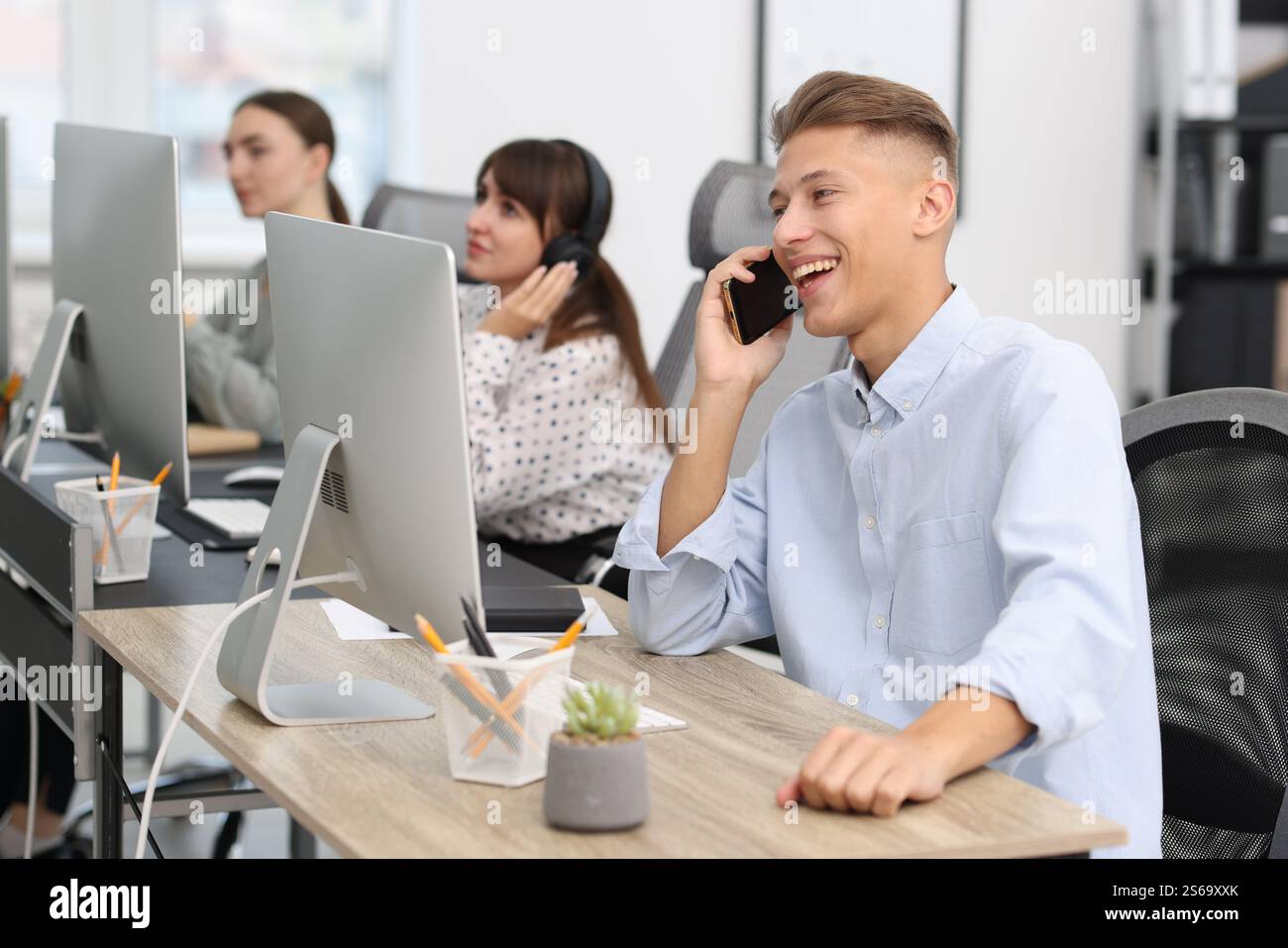 Sales department. People calling to clients in office, selective focus ...