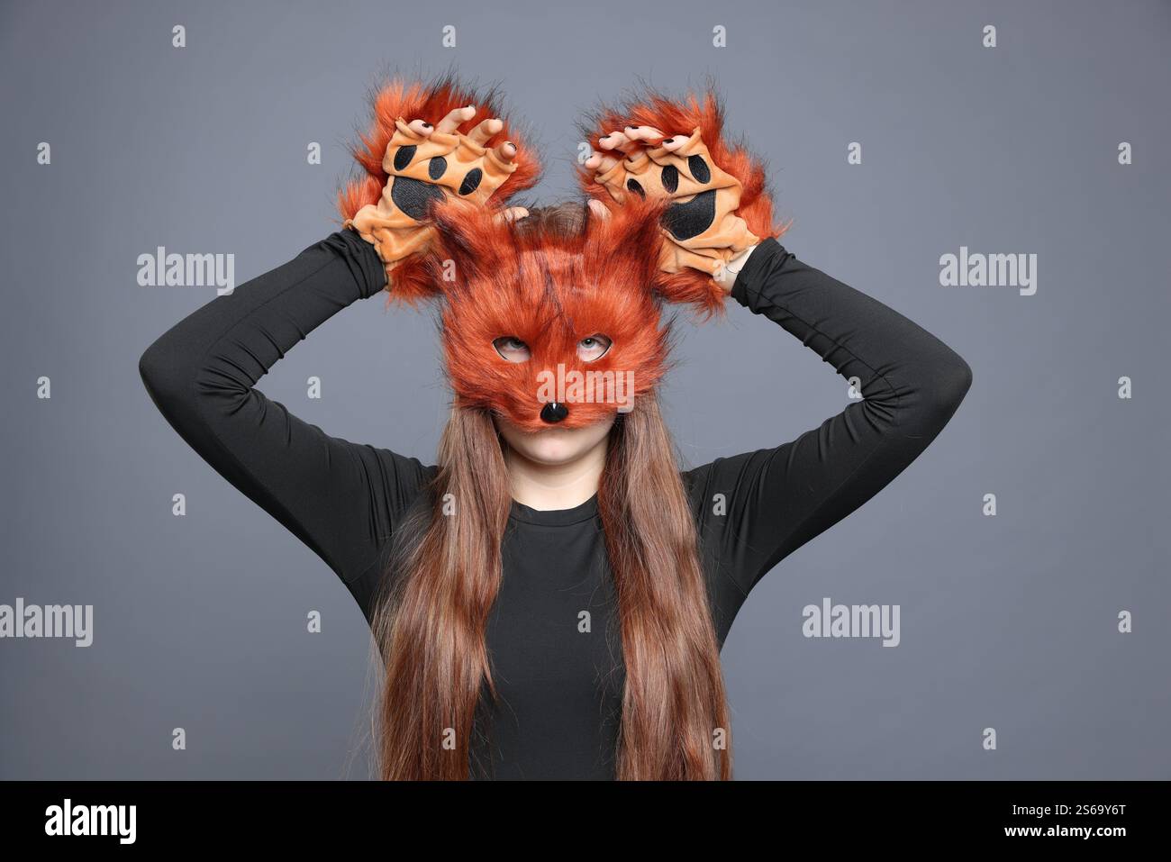 Quadrobics. Girl wearing fox mask and gloves on grey background Stock ...