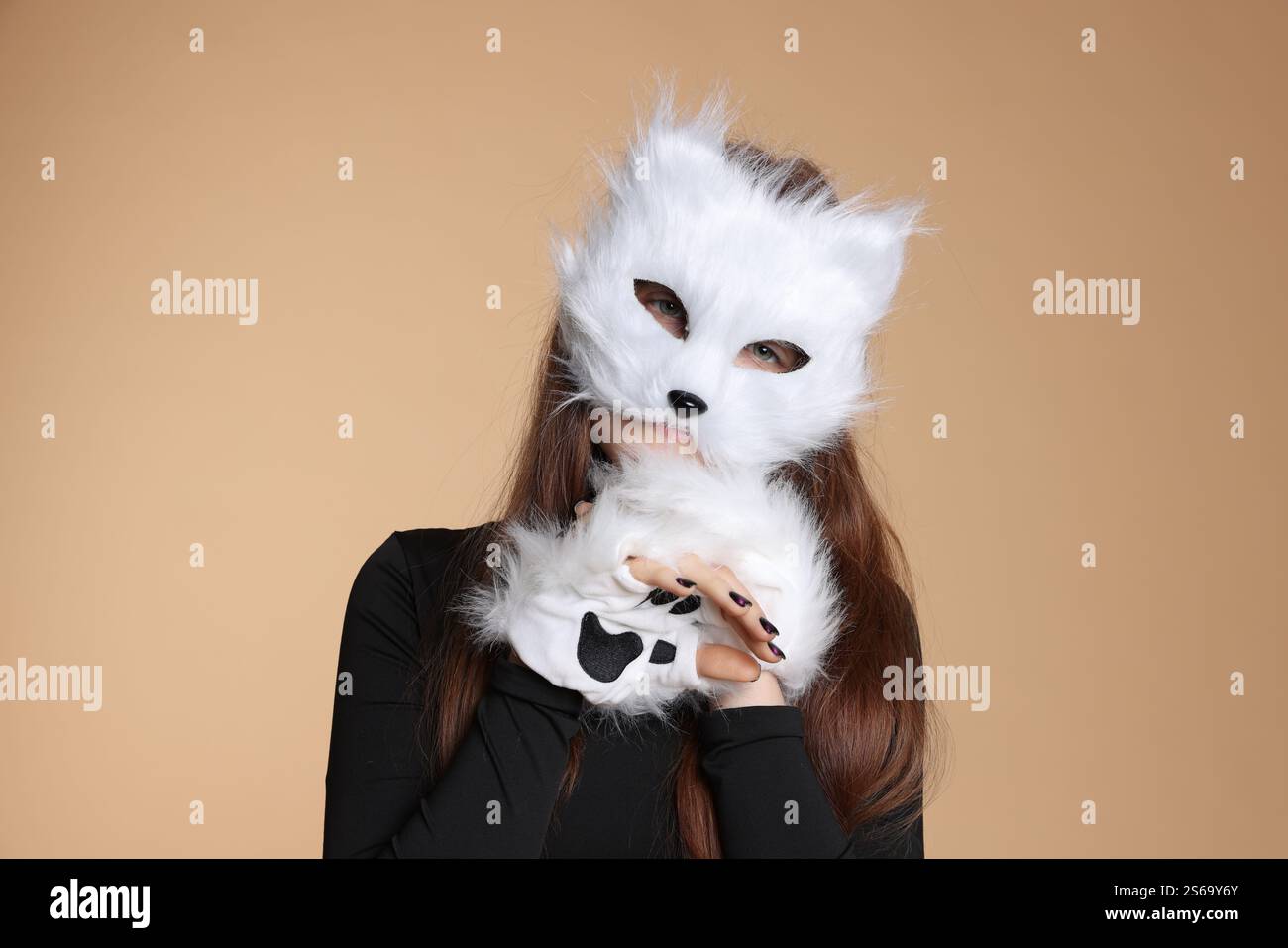 Quadrobics. Girl wearing cat mask and gloves on beige background Stock ...