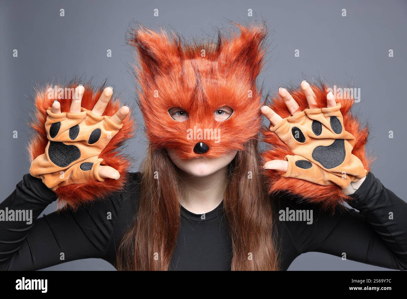 Quadrobics. Girl wearing fox mask and gloves on grey background Stock ...