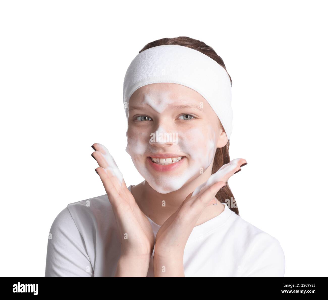 Teenage girl washing her face with cleanser on white background ...