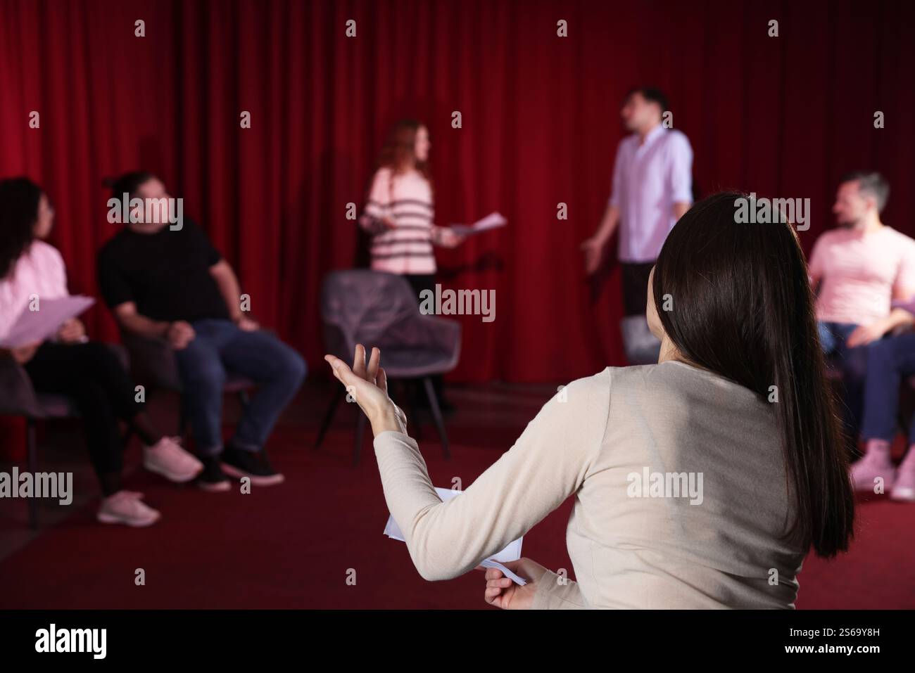 Professional actors with their scripts rehearsing in theatre Stock ...