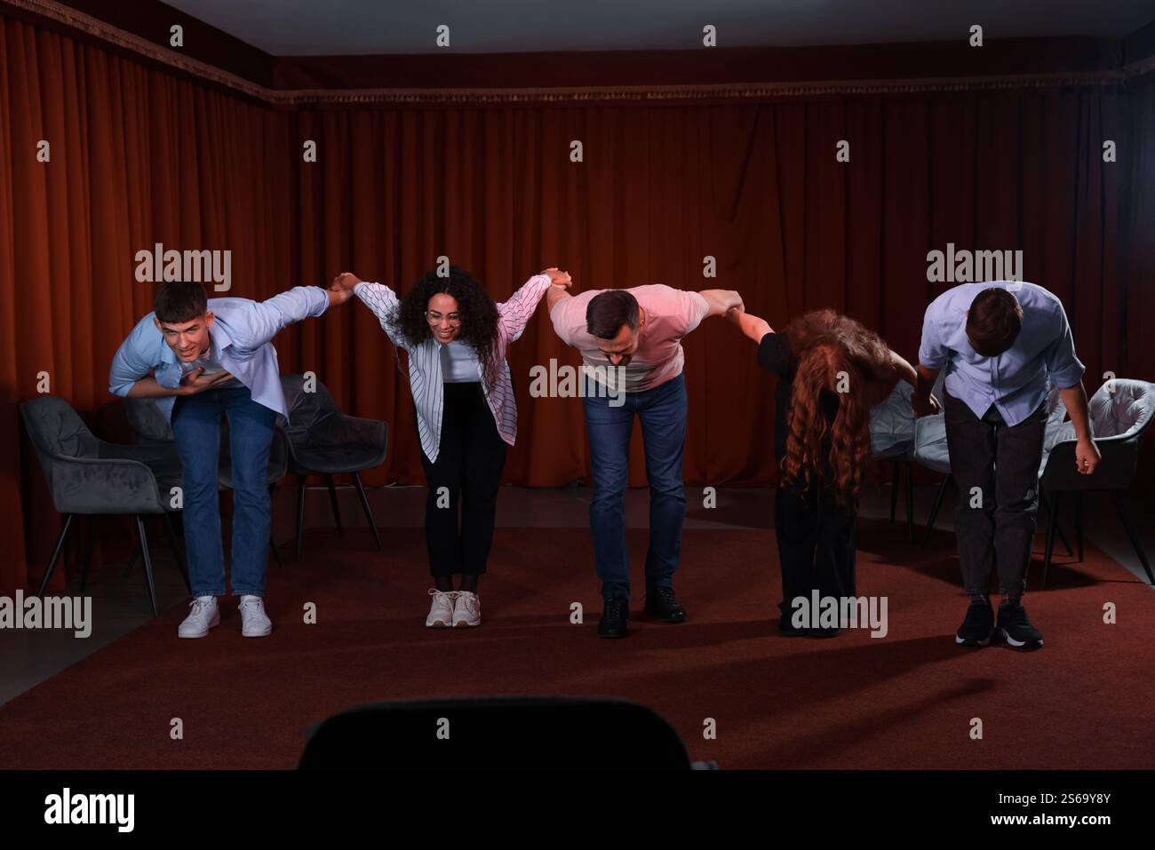 Professional actors bowing on stage in theatre Stock Photo - Alamy