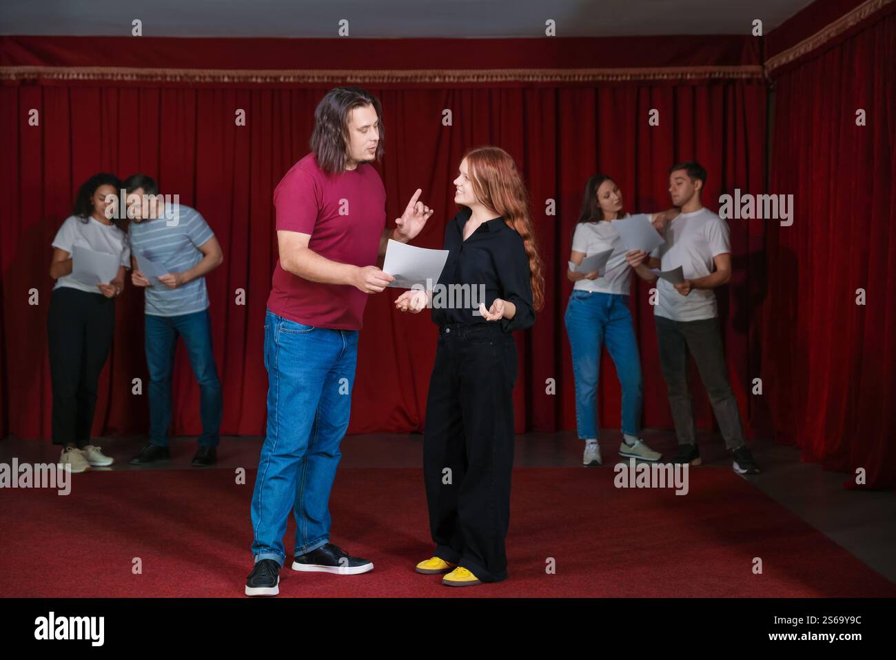 Professional actors with their scripts rehearsing in theatre Stock ...