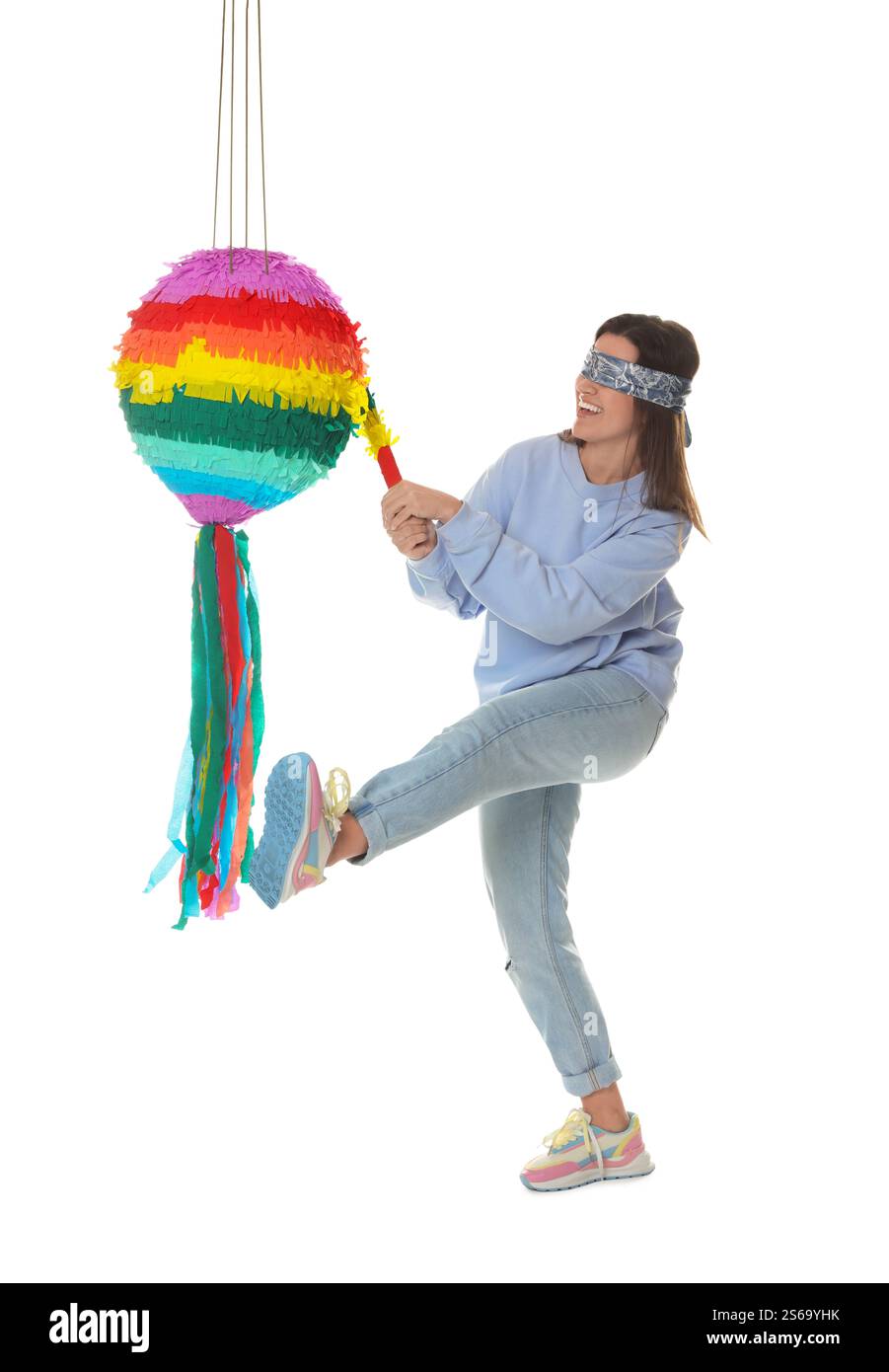 Woman with tied eyes breaking pinata on white background Stock Photo ...