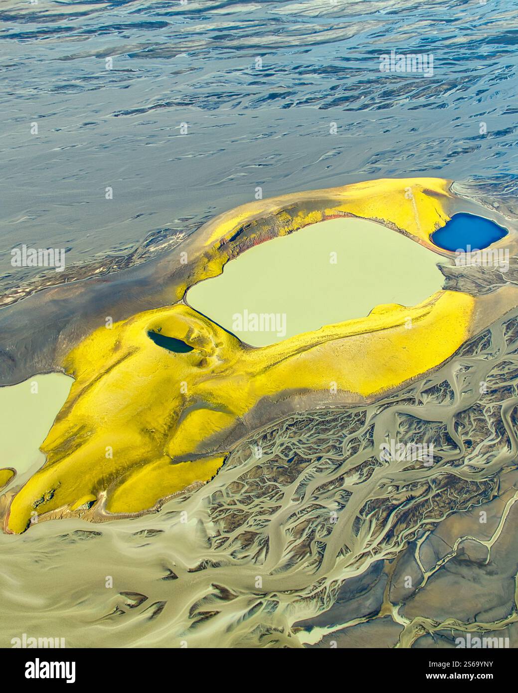 Aerial view of vibrant geothermal lakes and braided river patterns in ...