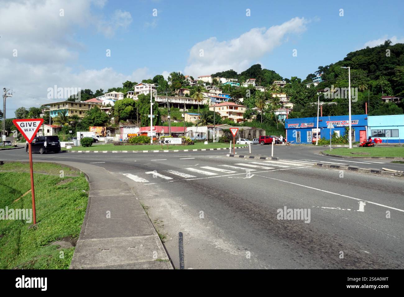 Road with roundabout and traffic sign, Give Way, passing the Caribbean ...