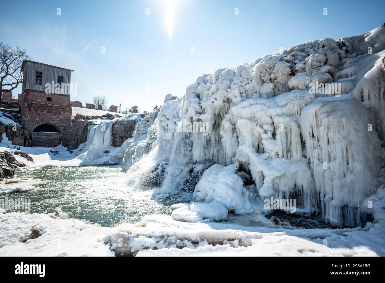 Sioux Falls Park waterfall with ice and snow. Cascading snowmelt water ...