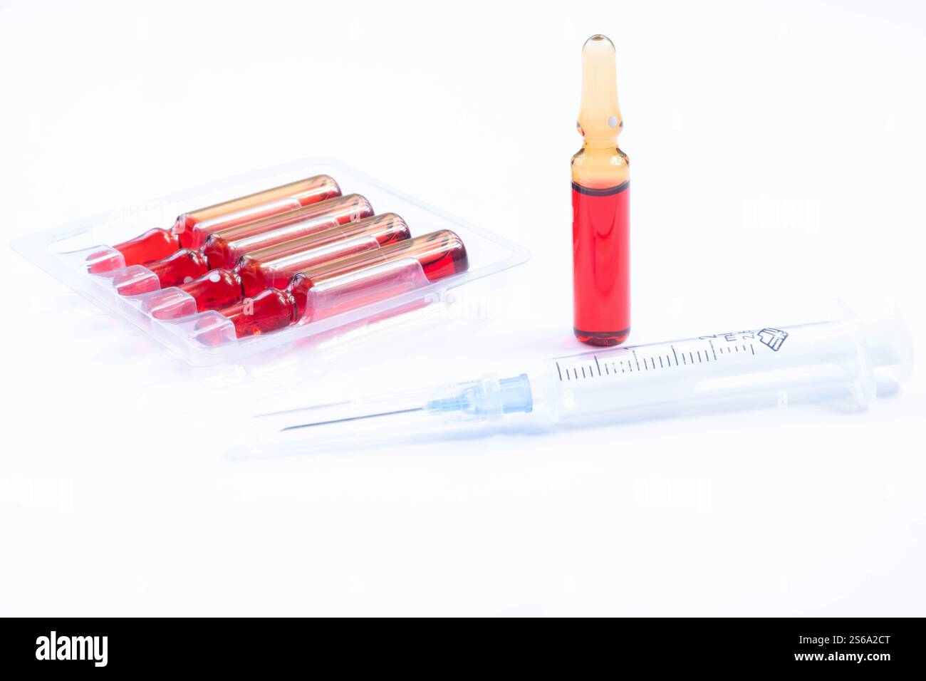 Course of injections of B vitamins. Ampoules with red liquid. Beauty ...