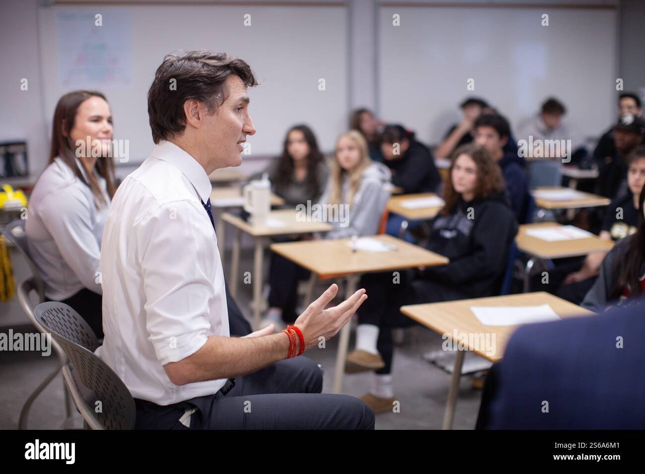 Prime Minister Justin Trudeau, left, visits with teacher Linda Morais ...