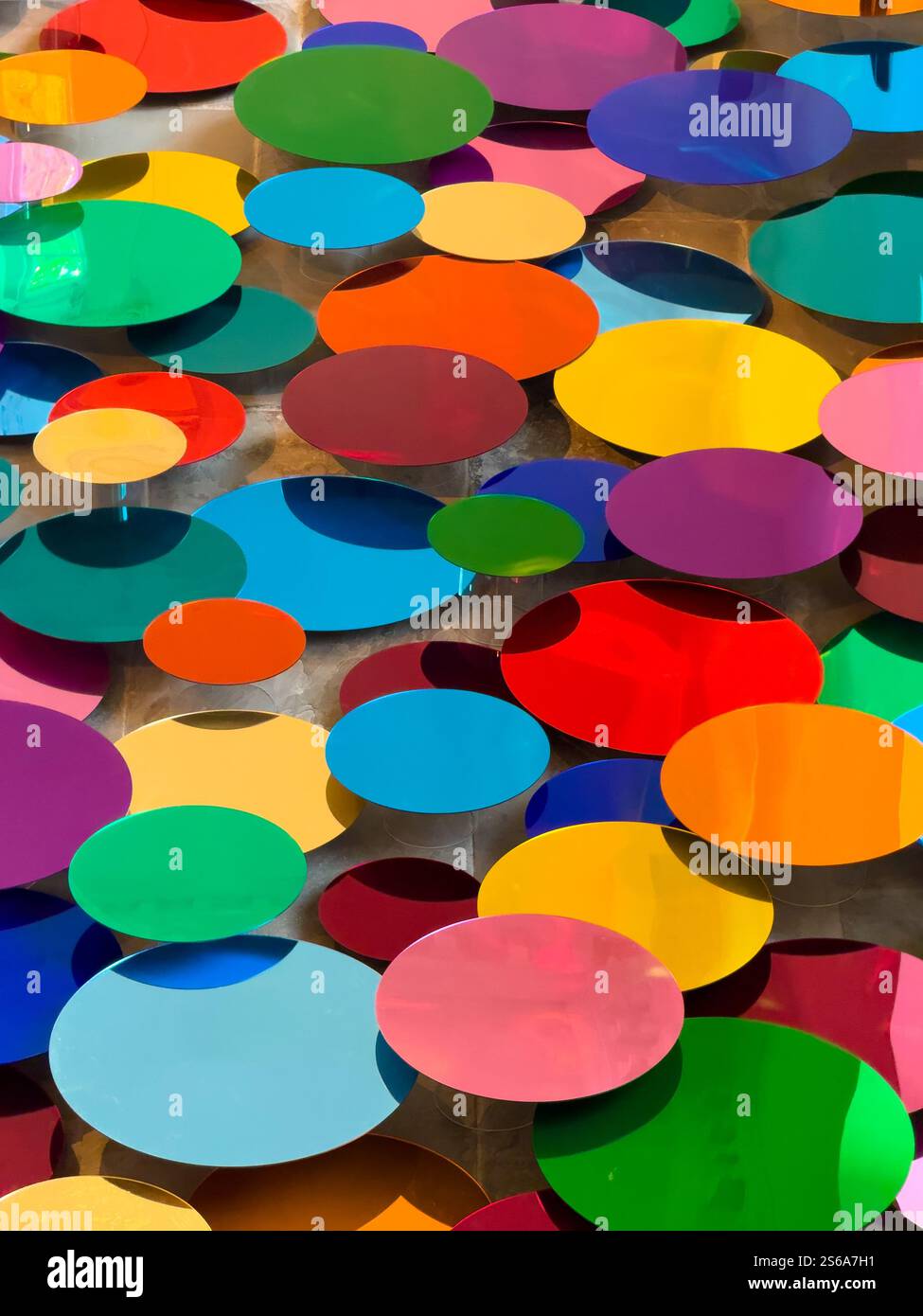 Brightly coloured mirrored discs used by Liz West for her art ...