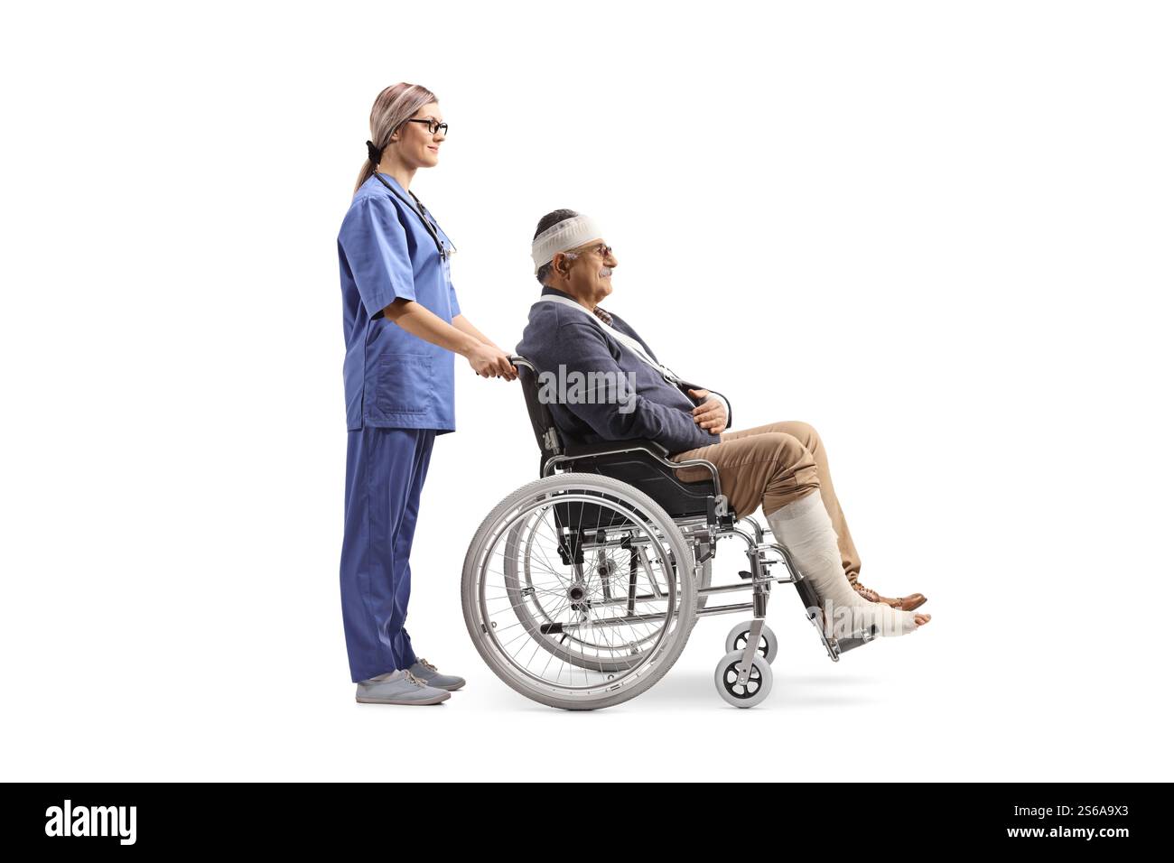 Nurse standing with a man in a wheelchair with head, arm and leg injury ...