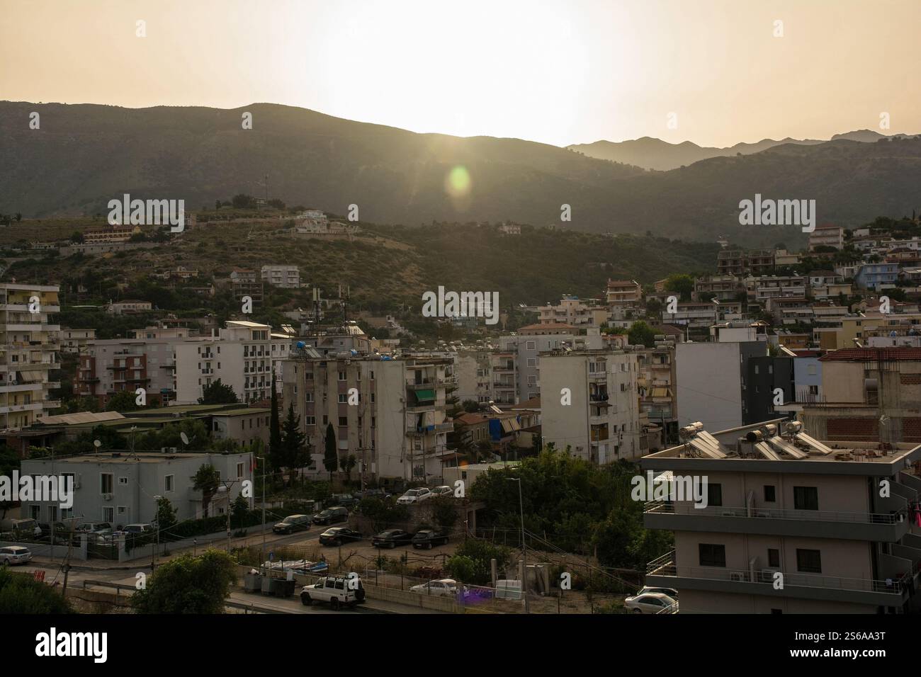 The dawn sun rises over Himare on the coast of southern Albania, part ...
