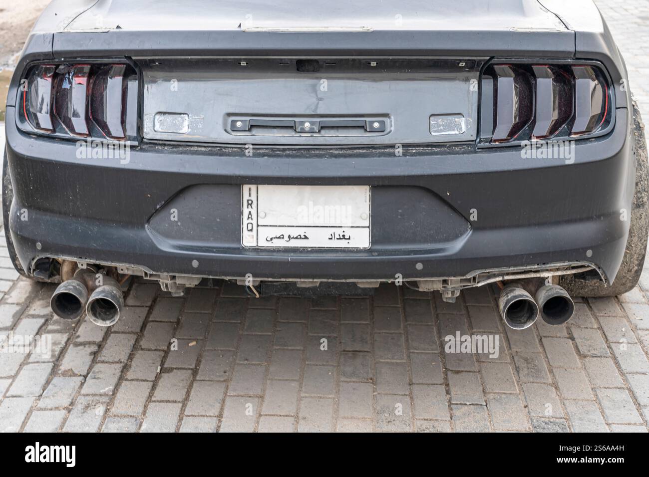 A black powerful sports car is parked in a narrow street in Basrah ...