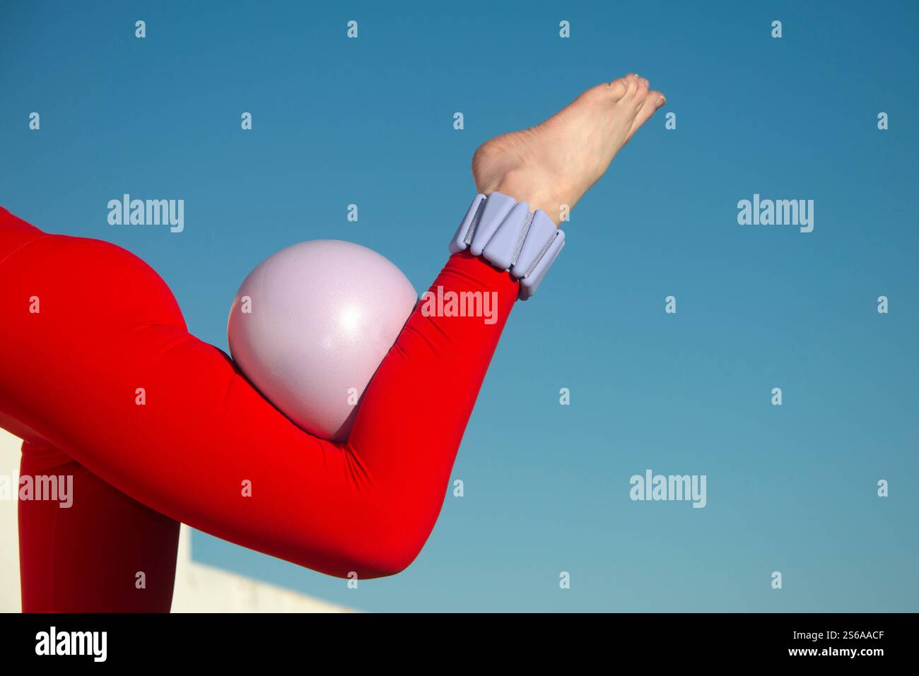 close up of womans legs in the air wearing adjustable ankle weights and ...