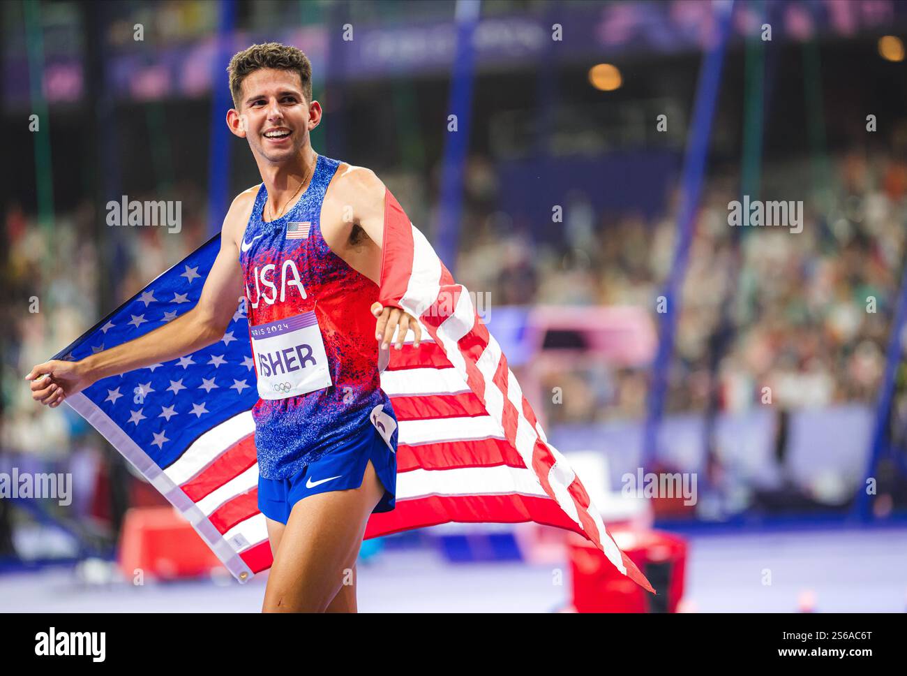 Grant Fisher celebrating her medal with her country's flag at the Paris ...