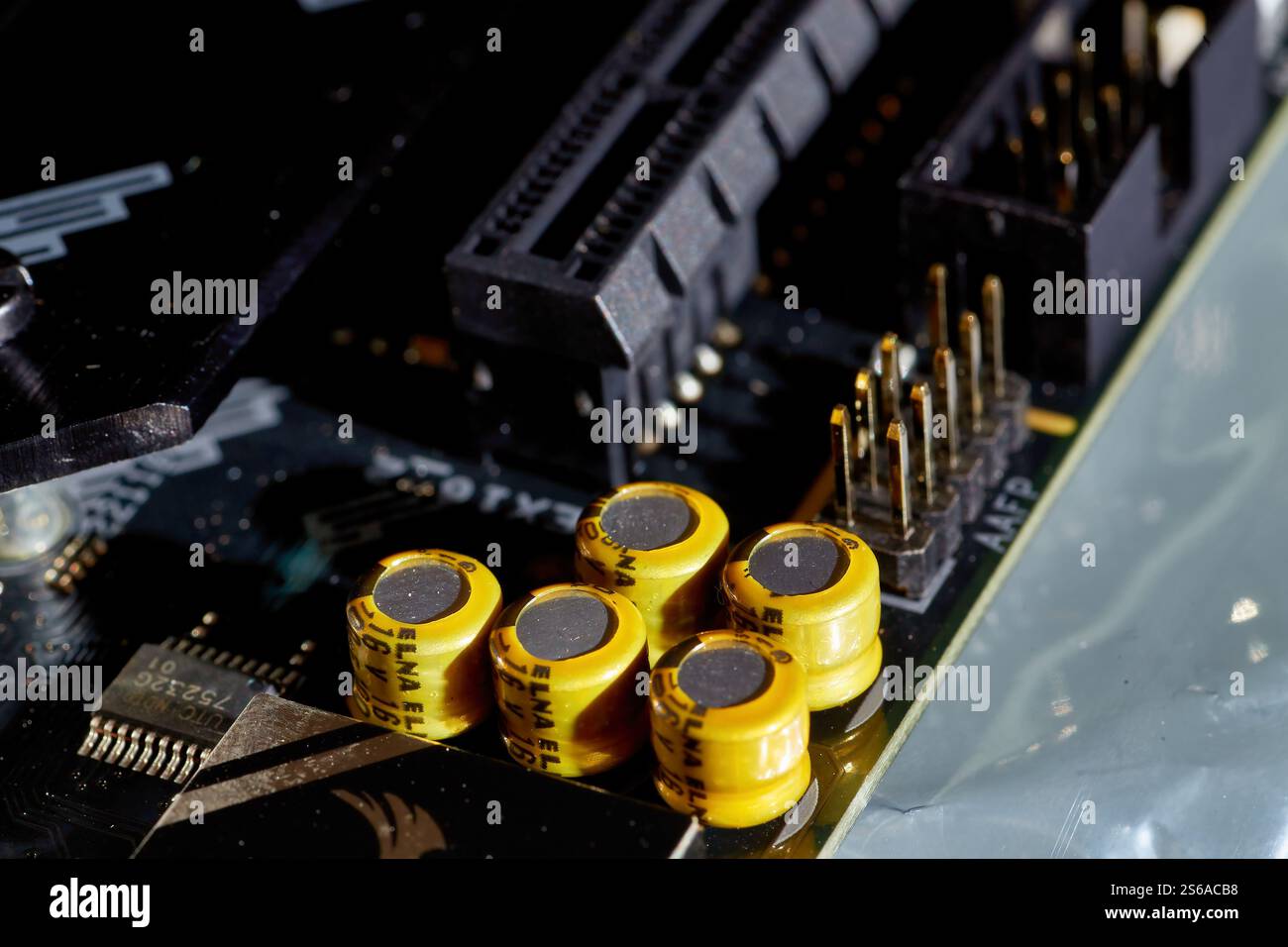 A detailed close-up of yellow capacitors on a motherboard, highlighting ...