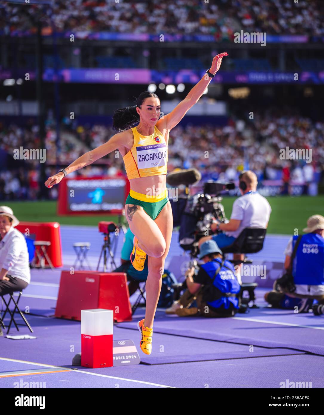 Diana Zagainova celebrating her medal with her country's flag at the ...