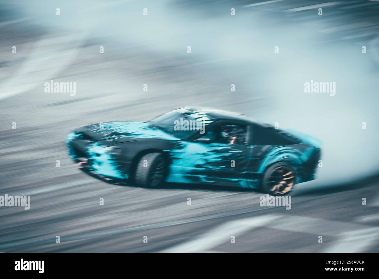 Abstract blurred racing drift car on turn of high speed track in motion ...