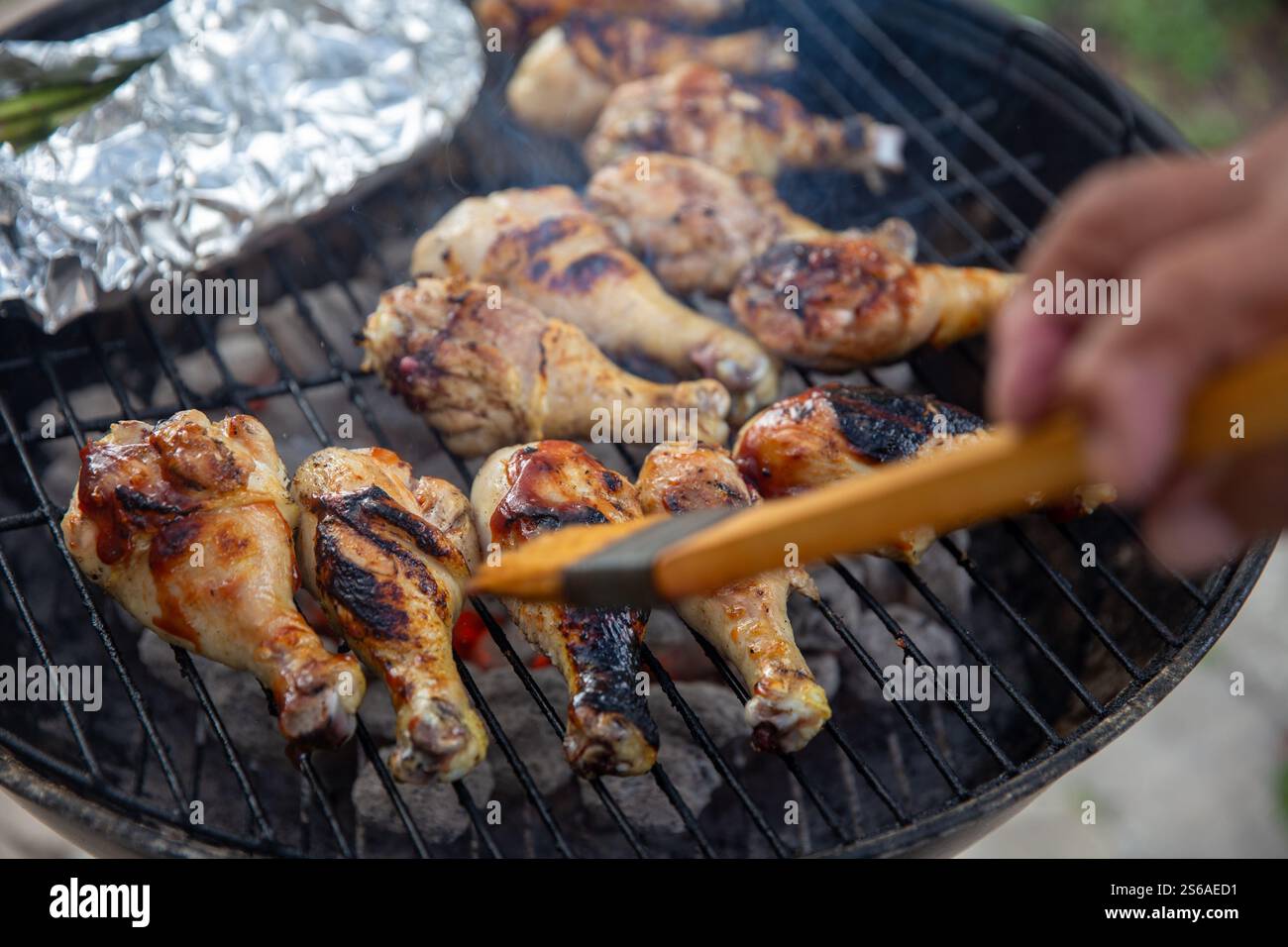 Chicken legs on the BBQ heated by coals Stock Photo - Alamy