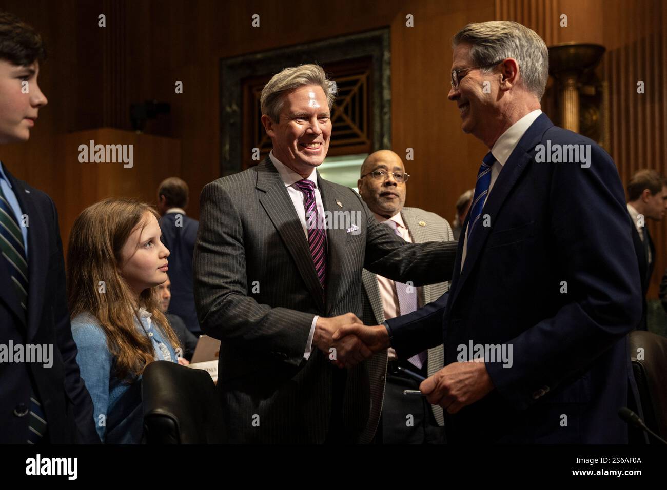 John Freeman, Scott Bessent's husband, shakes hands with his spouse after Bessent's confirmation ...