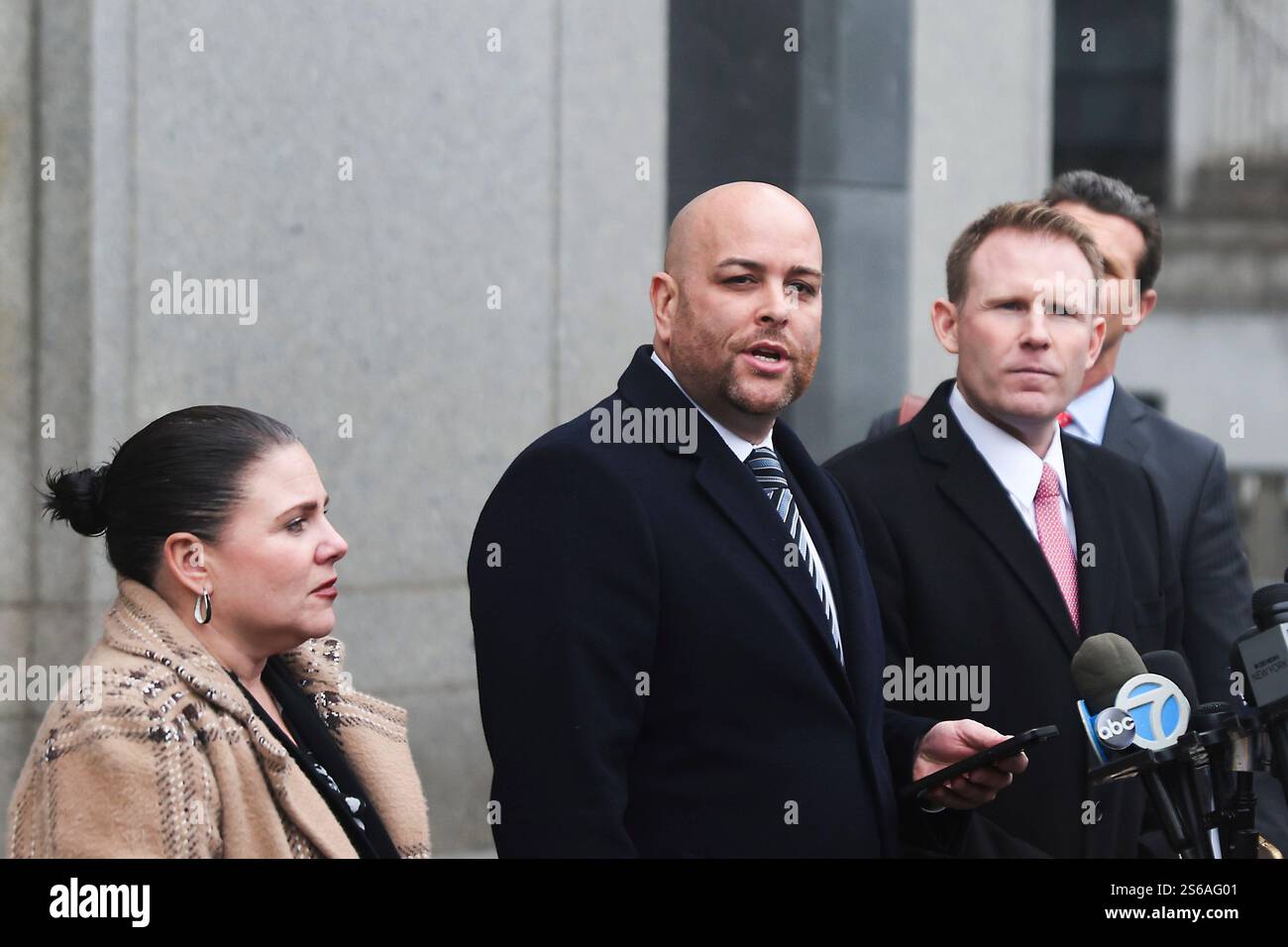 Attorney Joseph Cammarata, center, reads a statement off his phone on ...