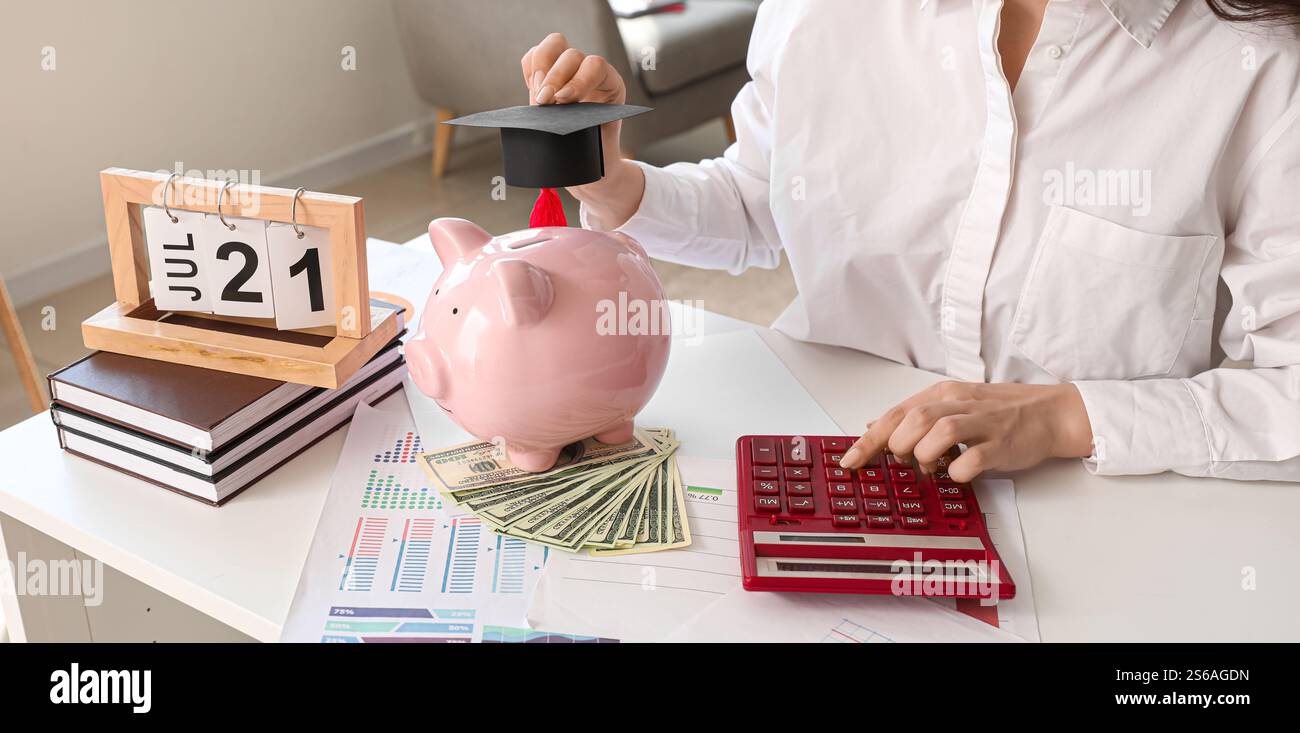 Female student calculating her finances at table. Concept of student ...
