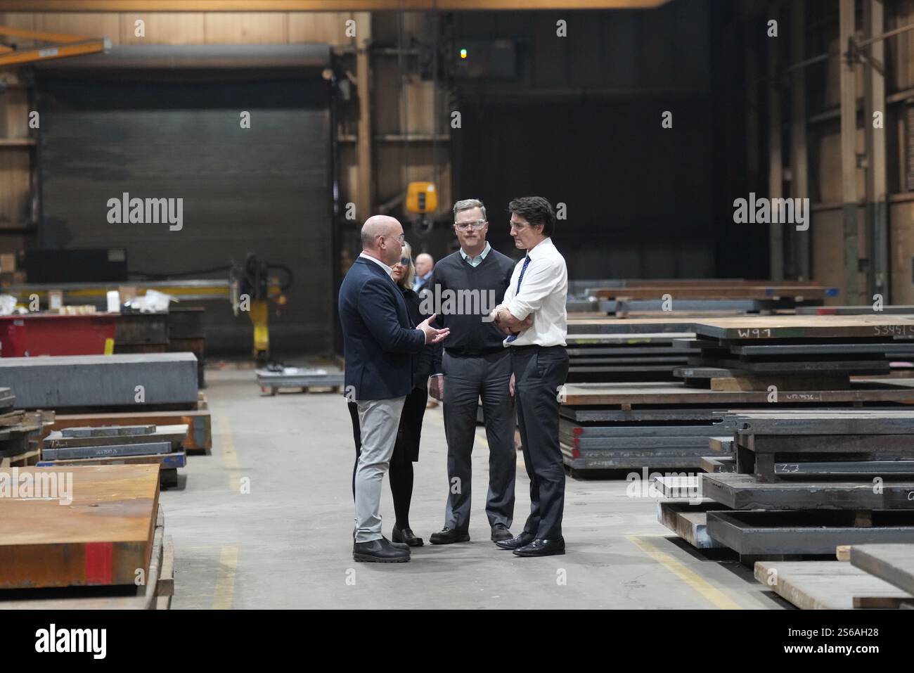 Prime Minister Justin Trudeau speaks with members of the management ...