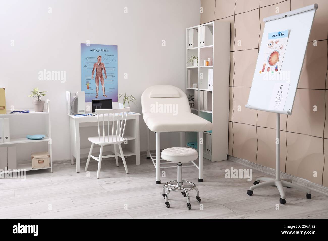 Interior of medical office with couch, shelf units and doctor's ...