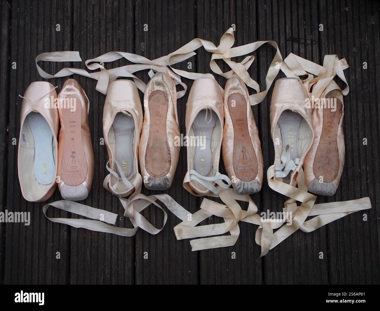 Four pairs of pointe shoes of the same kind laid out to show the ...