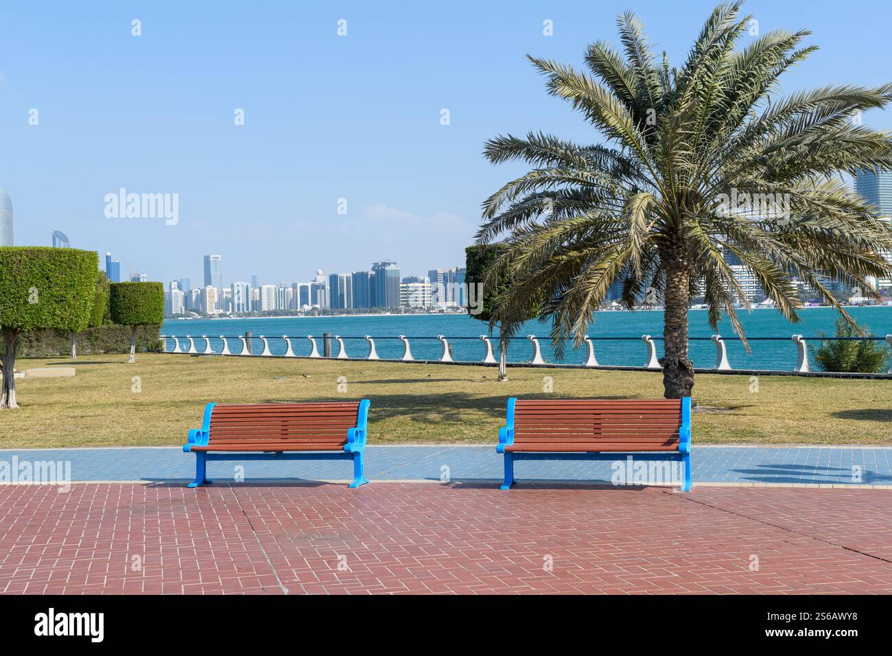 Abu Dhabi, UAE - January 3, 2025: A serene waterfront park with two ...