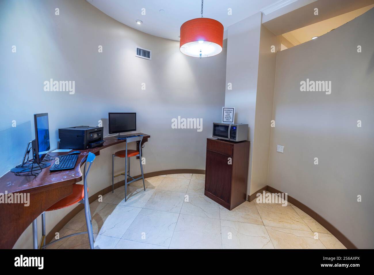 Hotel business center with two computers, printer and microwave on ...