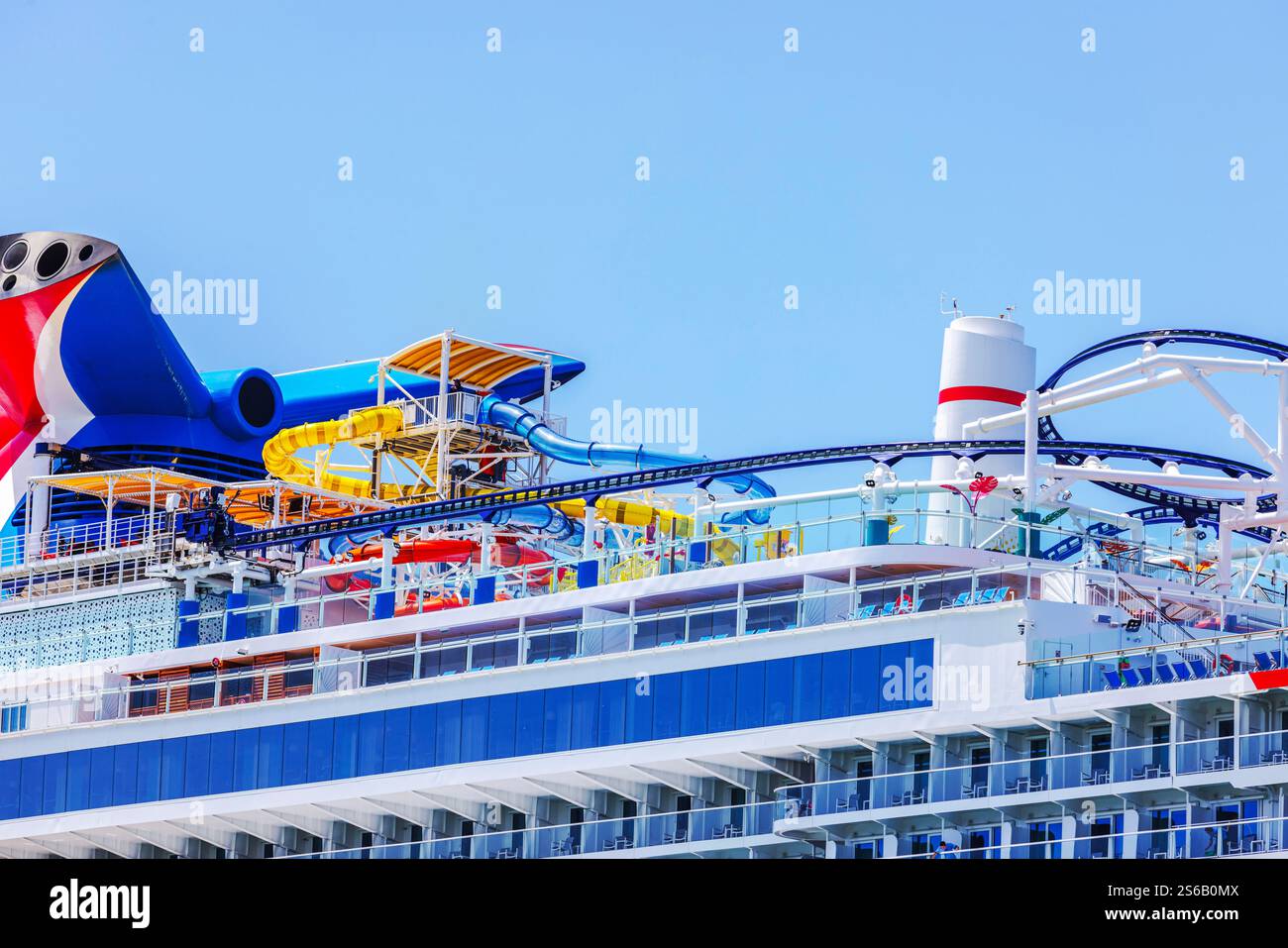 Close-up view of cruise ship deck featuring roller coaster, colorful ...