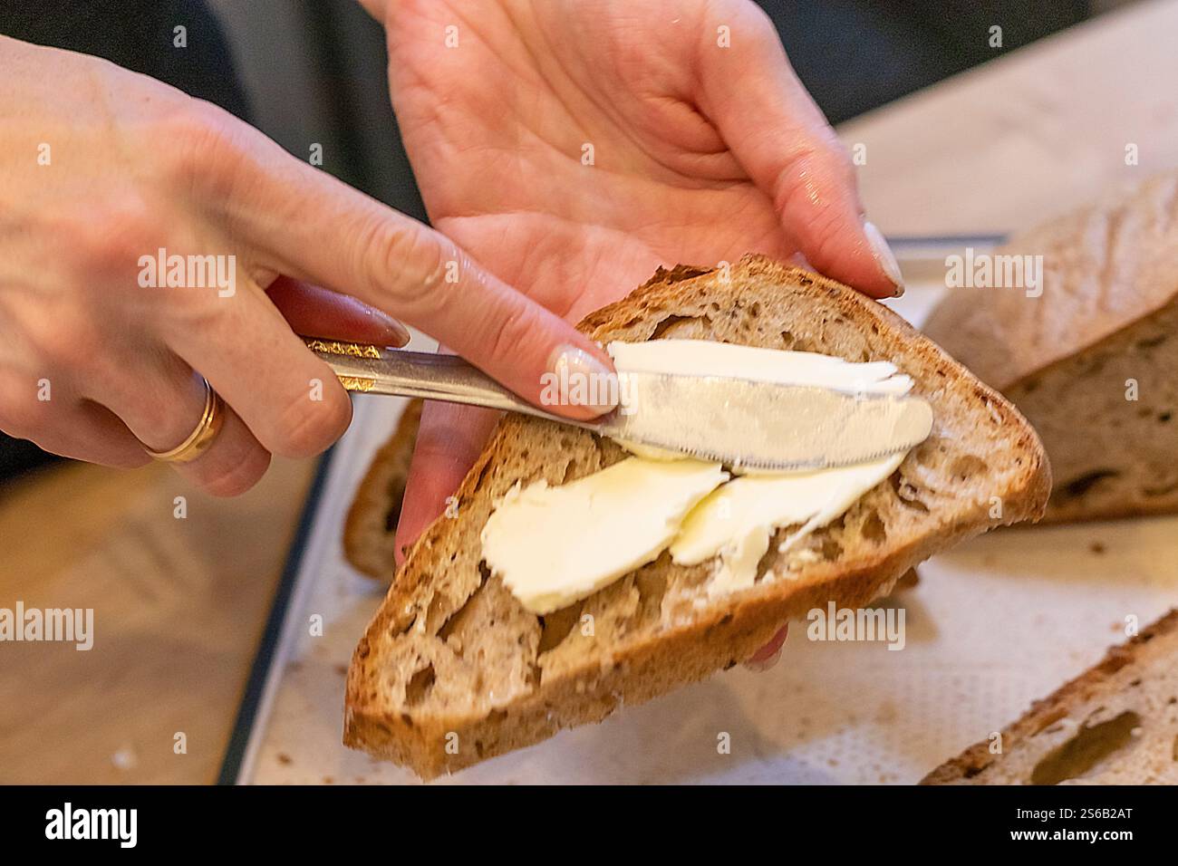 Woman spreads butter on baking hi-res stock photography and images - Alamy