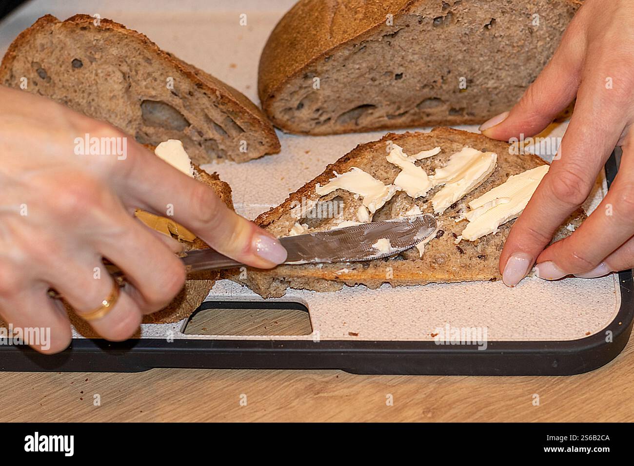 Woman spreads butter on baking hi-res stock photography and images - Alamy