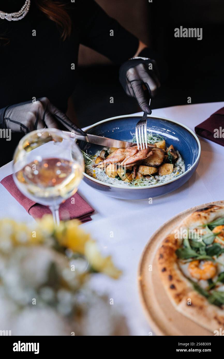 Elegant fine dining experience with grilled chicken, wine, and a sophisticated table setting ...