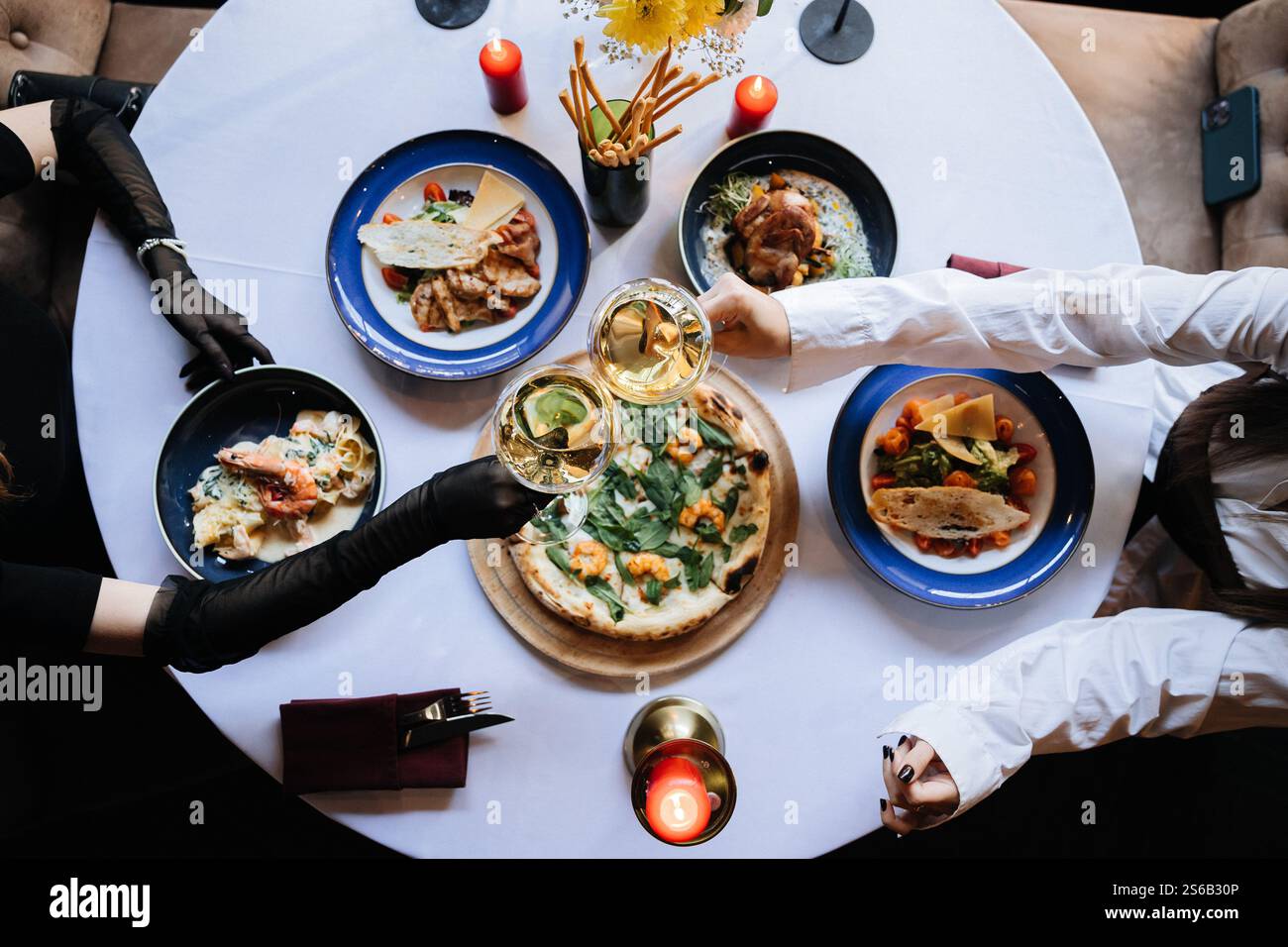 Celebratory dinner with wine, gourmet dishes, and elegance at a fine ...