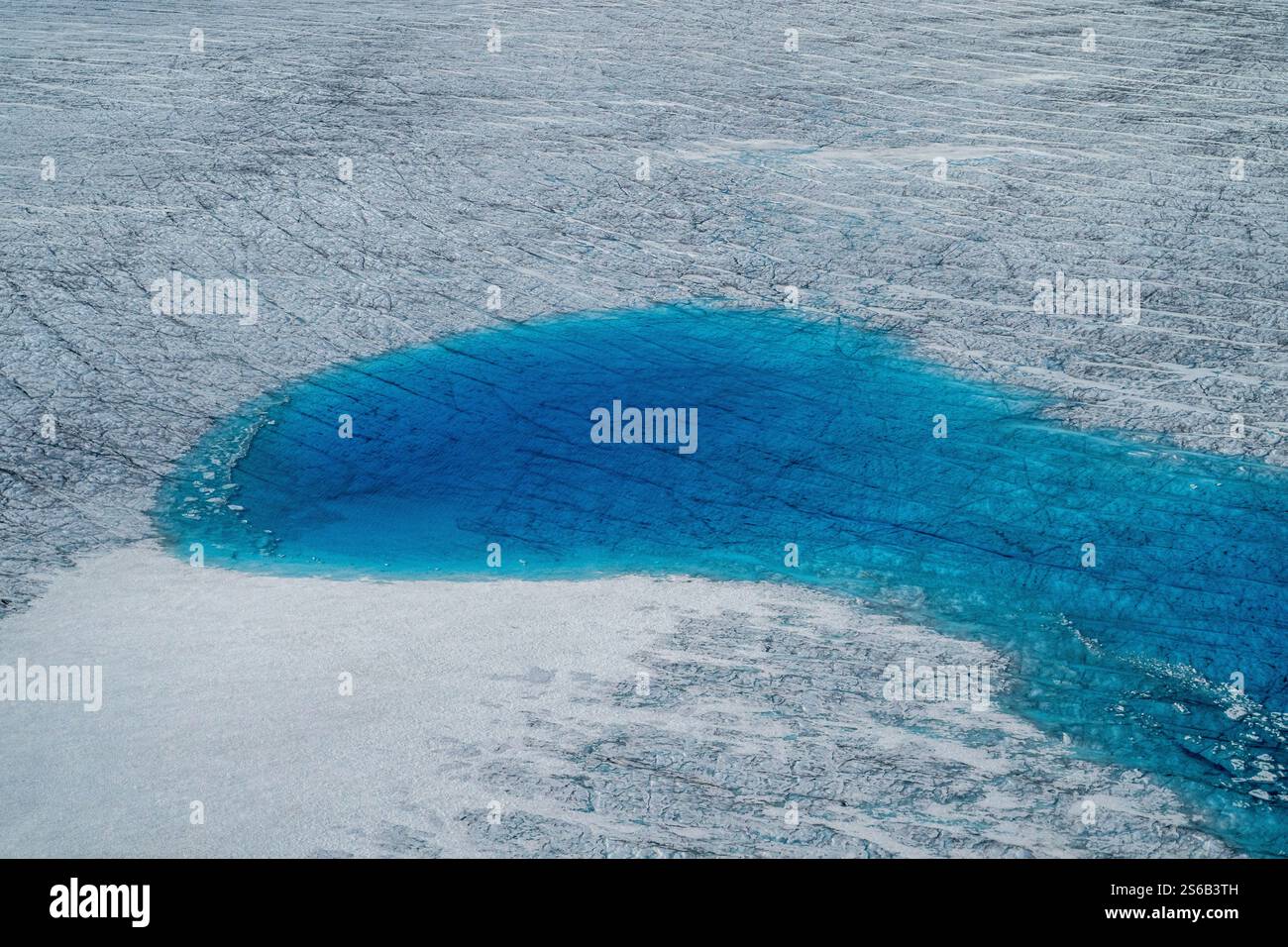 Bright blue pool forms on glacier surface during summer melt season ...