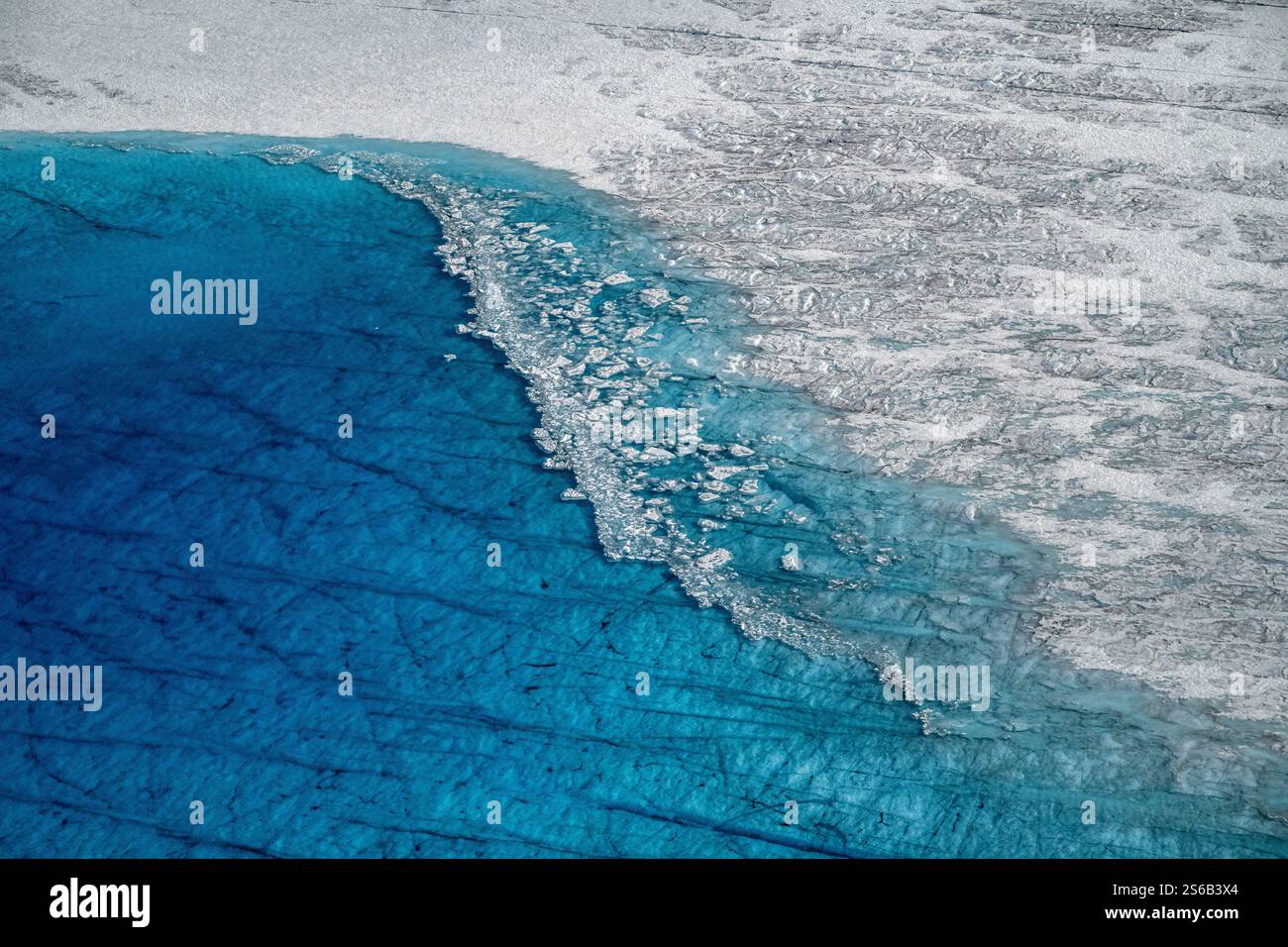 Bright blue pool forms on glacier surface during summer melt season ...
